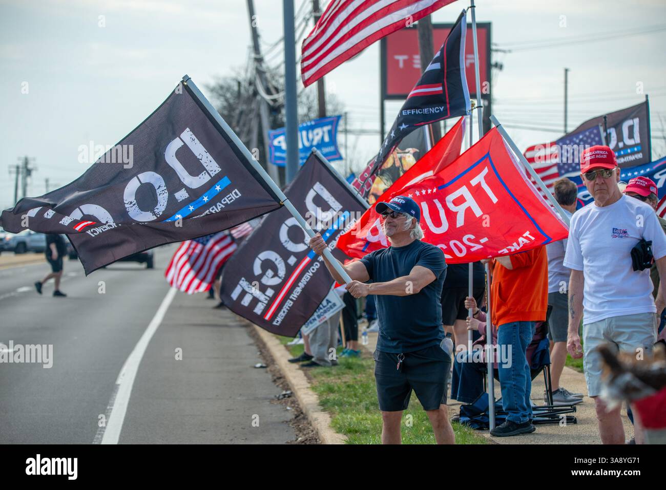 Warminster, Pennsylvania, USA. 29th Mar 2025. People wave flags during ...