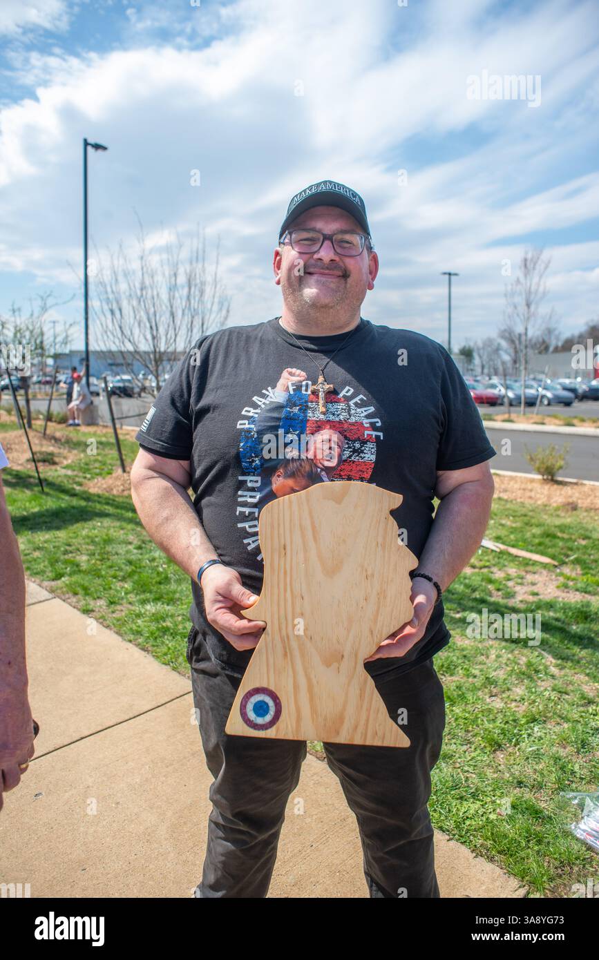 Warminster, Pennsylvania, USA. 29th Mar 2025. People wave flags during ...