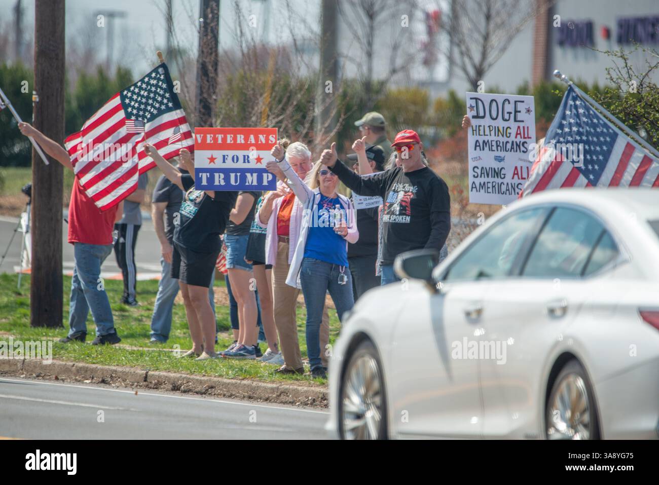 Warminster, Pennsylvania, USA. 29th Mar 2025. People wave flags during ...