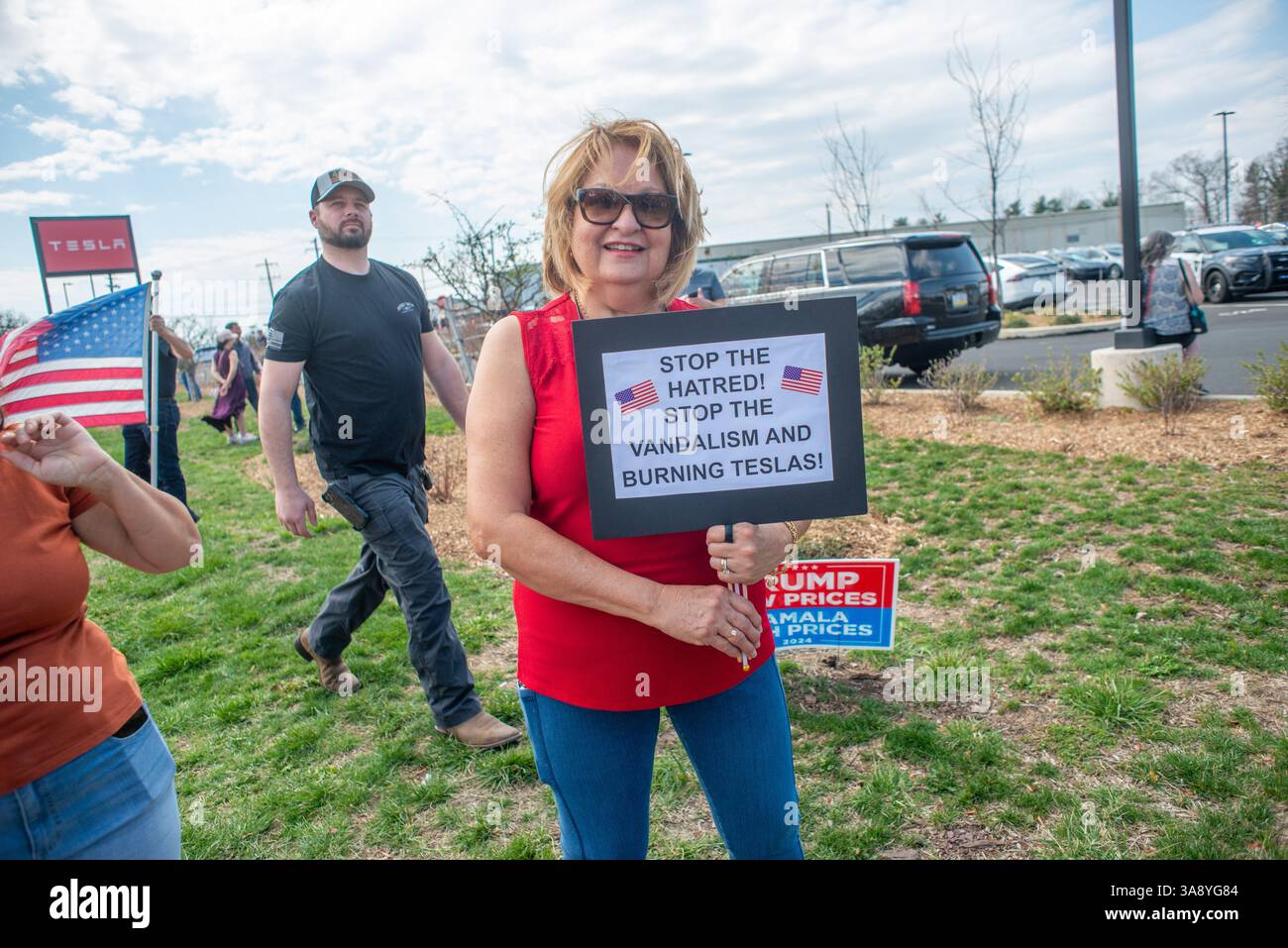 People wave flags during a rally in support of US President Trump, Elon ...