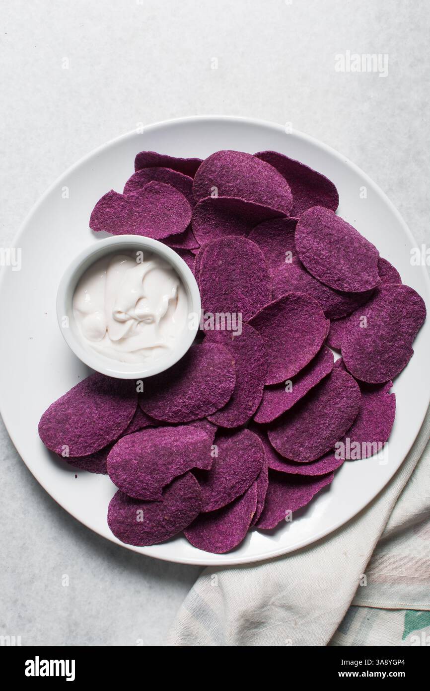 Overhead view of purple sweet potato chips and dip, top view of ube ...