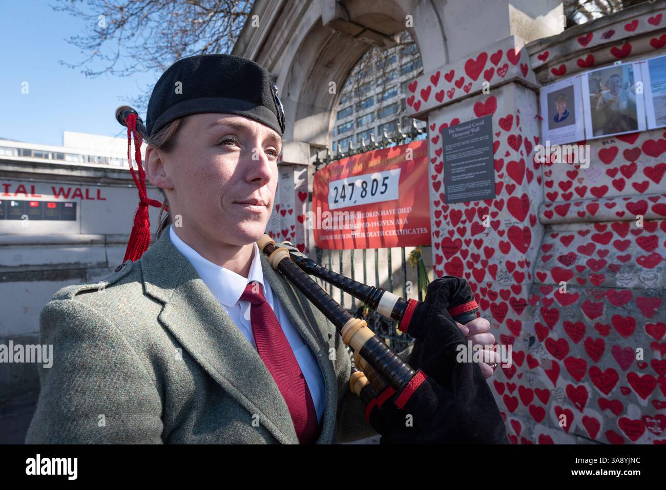 London, UK. 29 March, 2025. Bagpiper Iona Scotson leads a procession of ...
