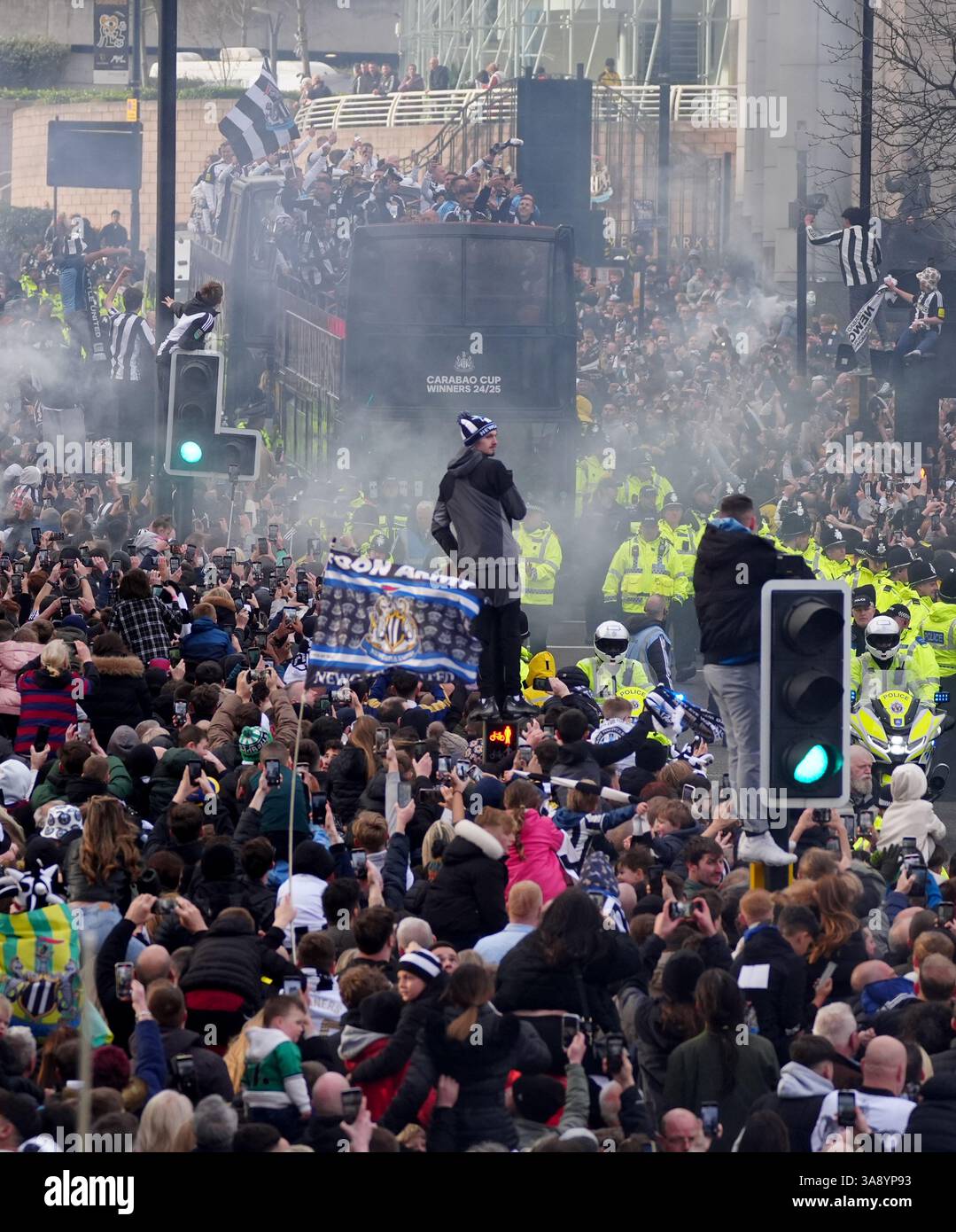 The open top buses carrying the Newcastle United players passes by fans ...