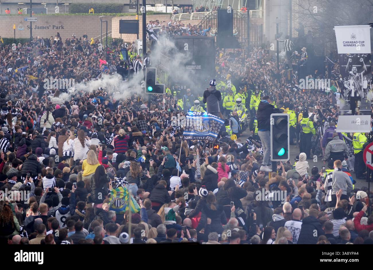 The open top buses carrying the Newcastle United players passes by fans ...