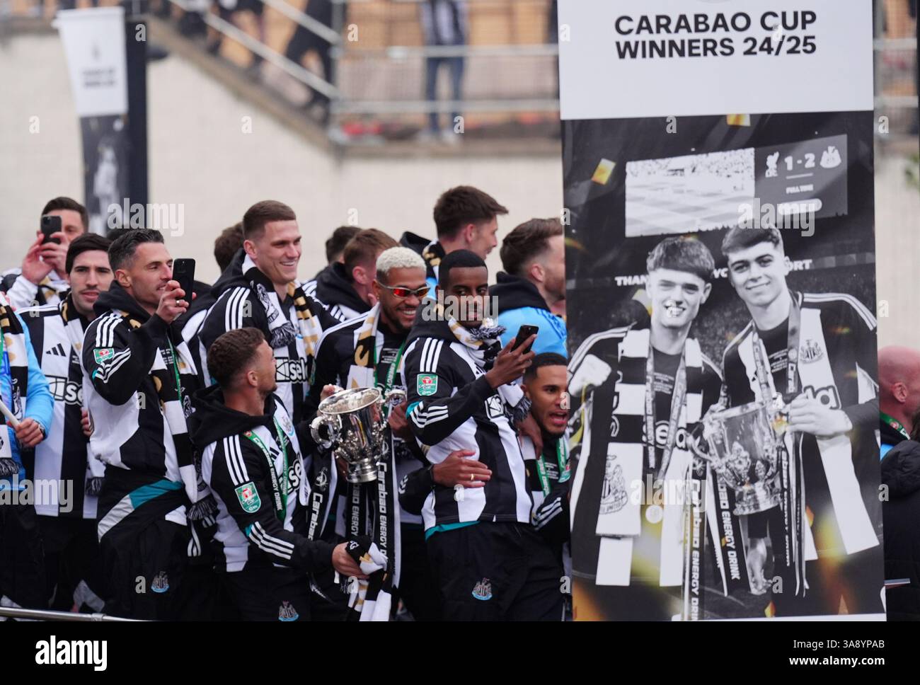 Newcastle United's players on board an open top bus passes by St James ...