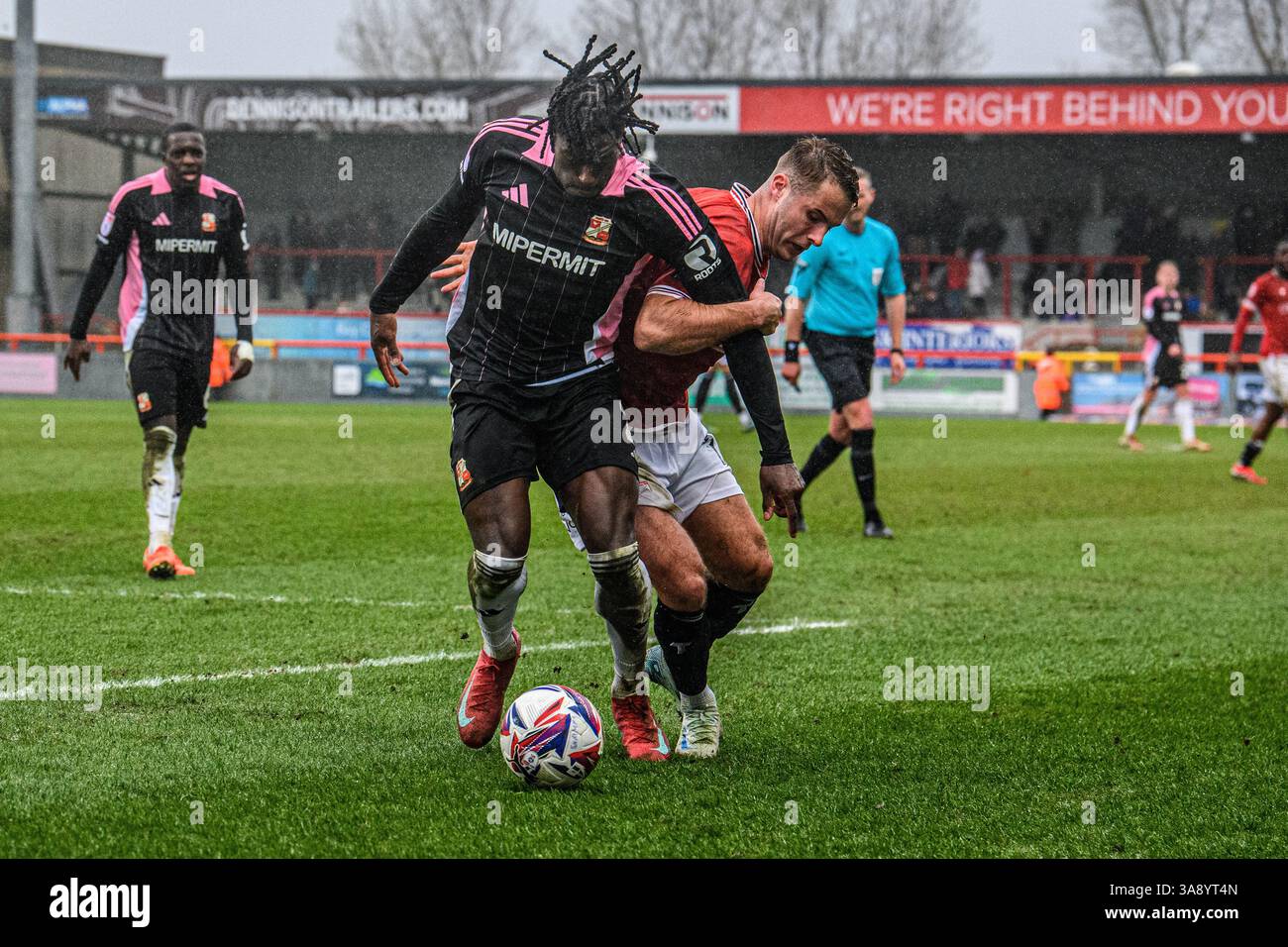 Tunmise Sobowale of Swindon Town tangles with Morecambe FC's Andrew ...