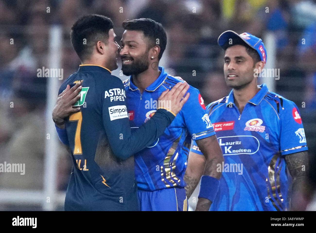 Gujarat Titans' Shubman Gill, left, and Mumbai Indians' captain Hardik Pandya hug after Gujarat ...