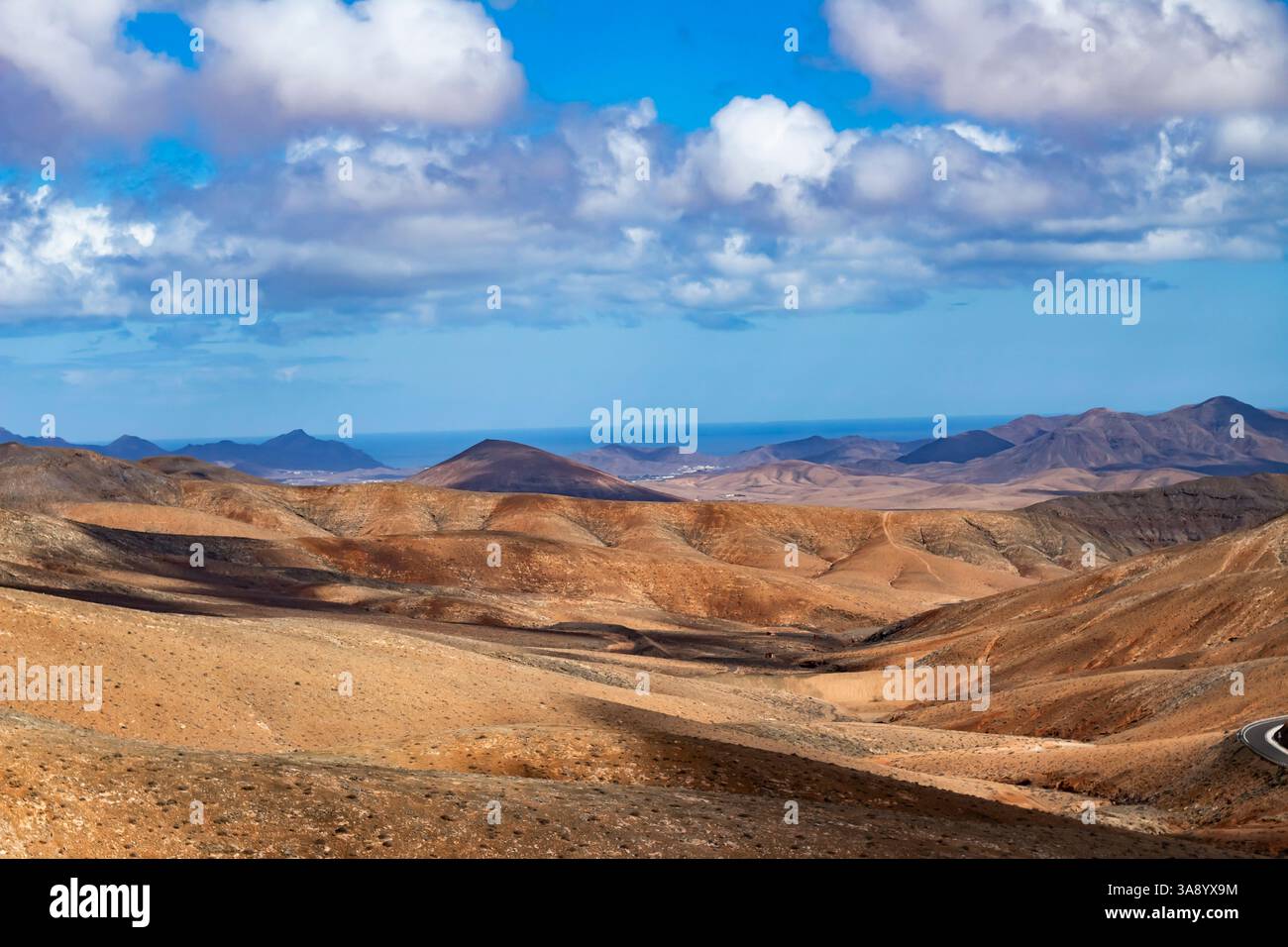Vast volcanic mountain range overlooking ocean horizon on Fuerteventura ...