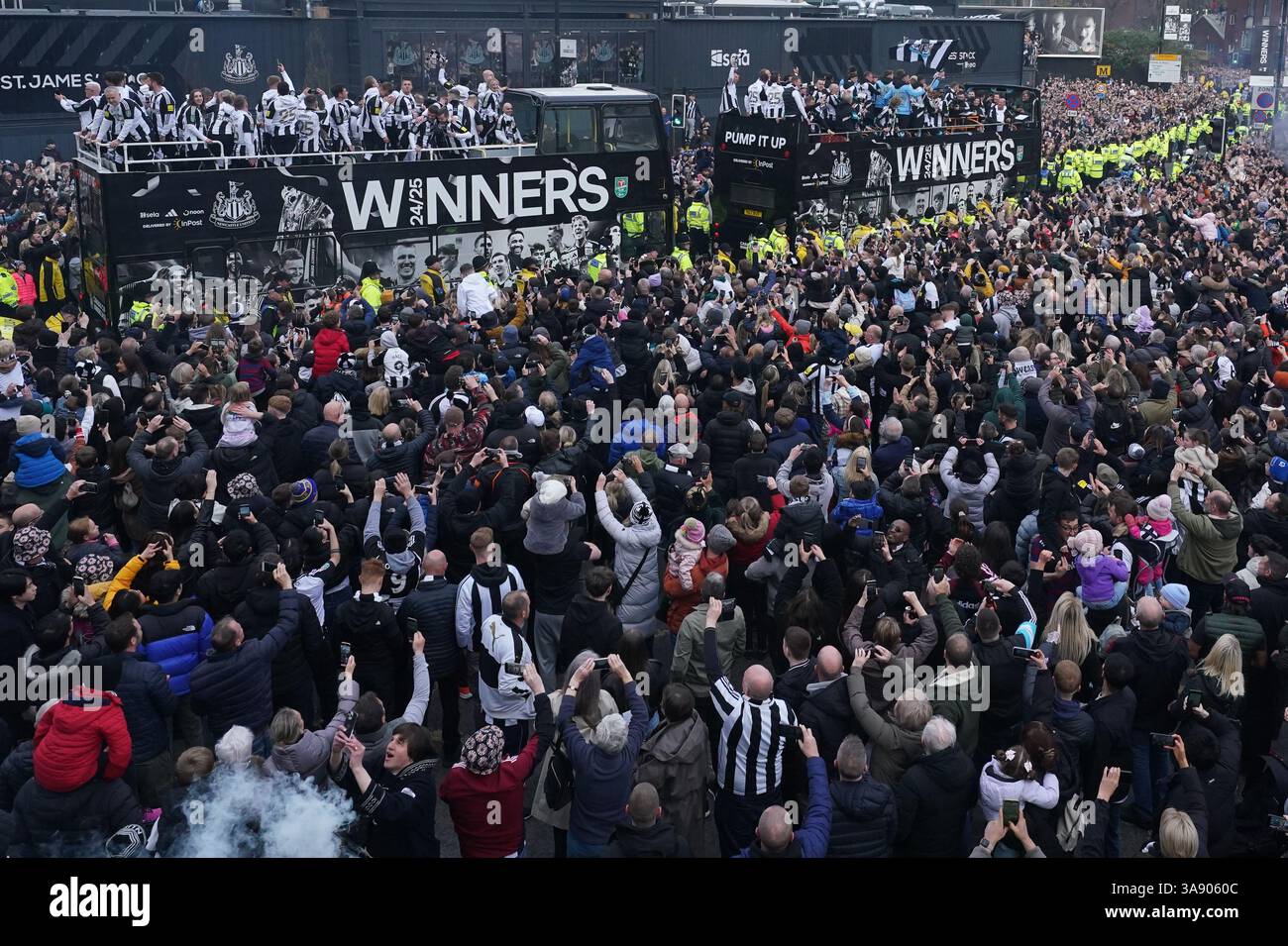 The open top buses carrying the Newcastle United players passes by fans ...