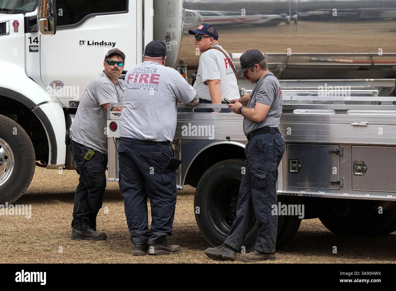 Figrefighters gather outside of the incident command post for the Table ...