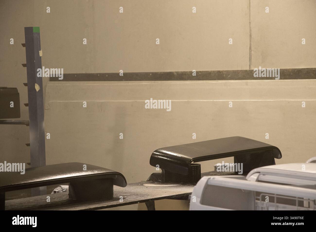 Paint shop, where air conditioner housings are laid out on tables for ...