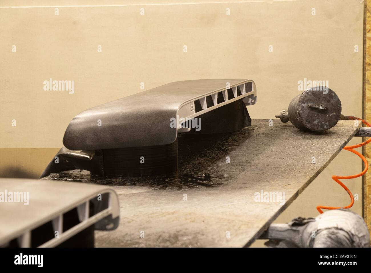 Paint shop, where air conditioner housings are laid out on tables for ...