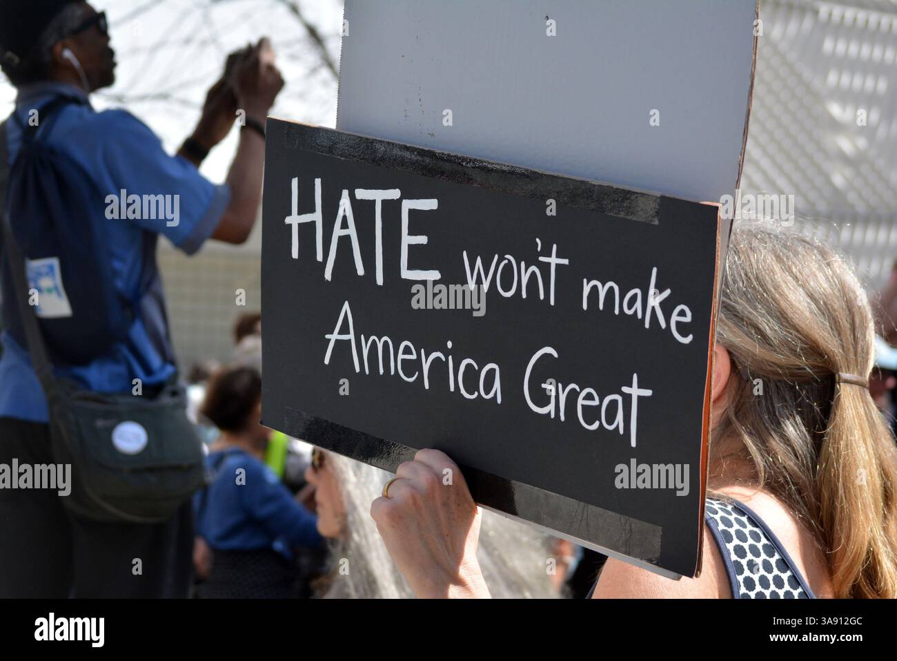 Tesla Takedown event against DOGE and Elon Musk marching to a Tesla ...