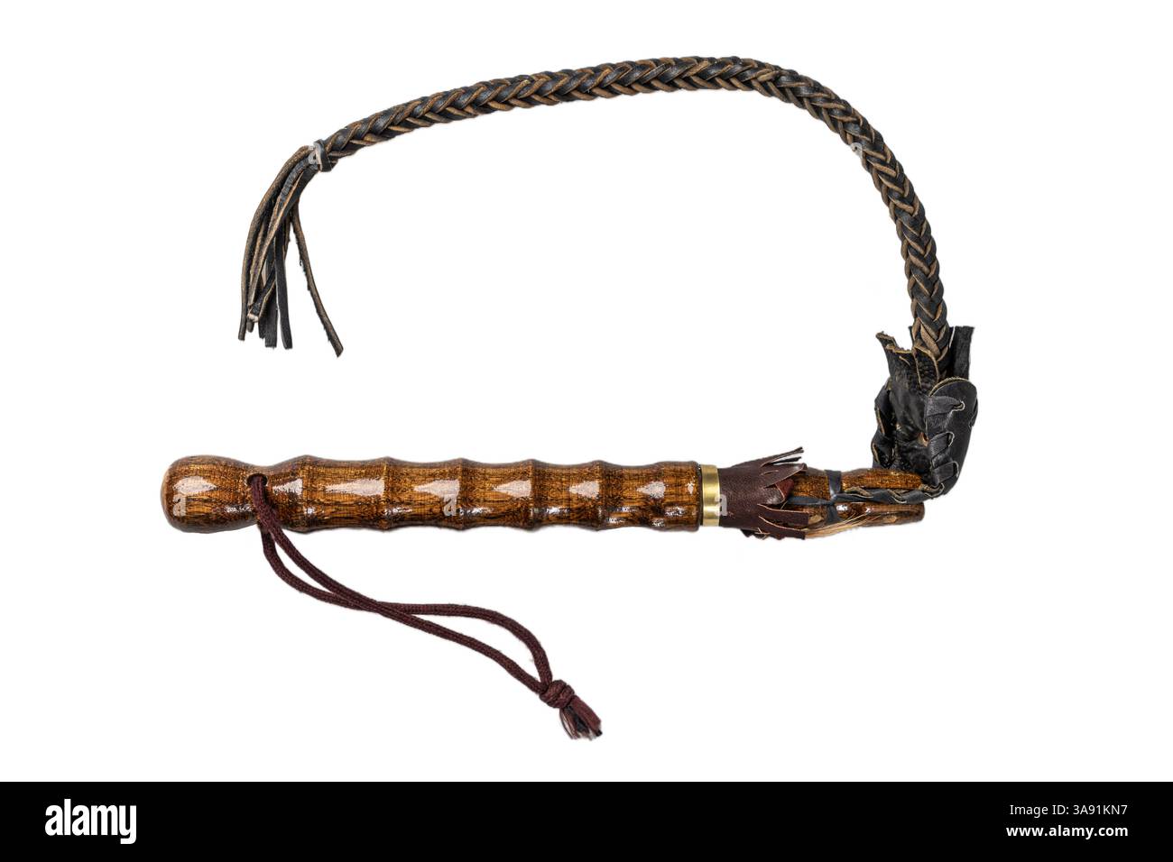 A wooden whip stick with a rope tied to it. The rope is frayed and the ...