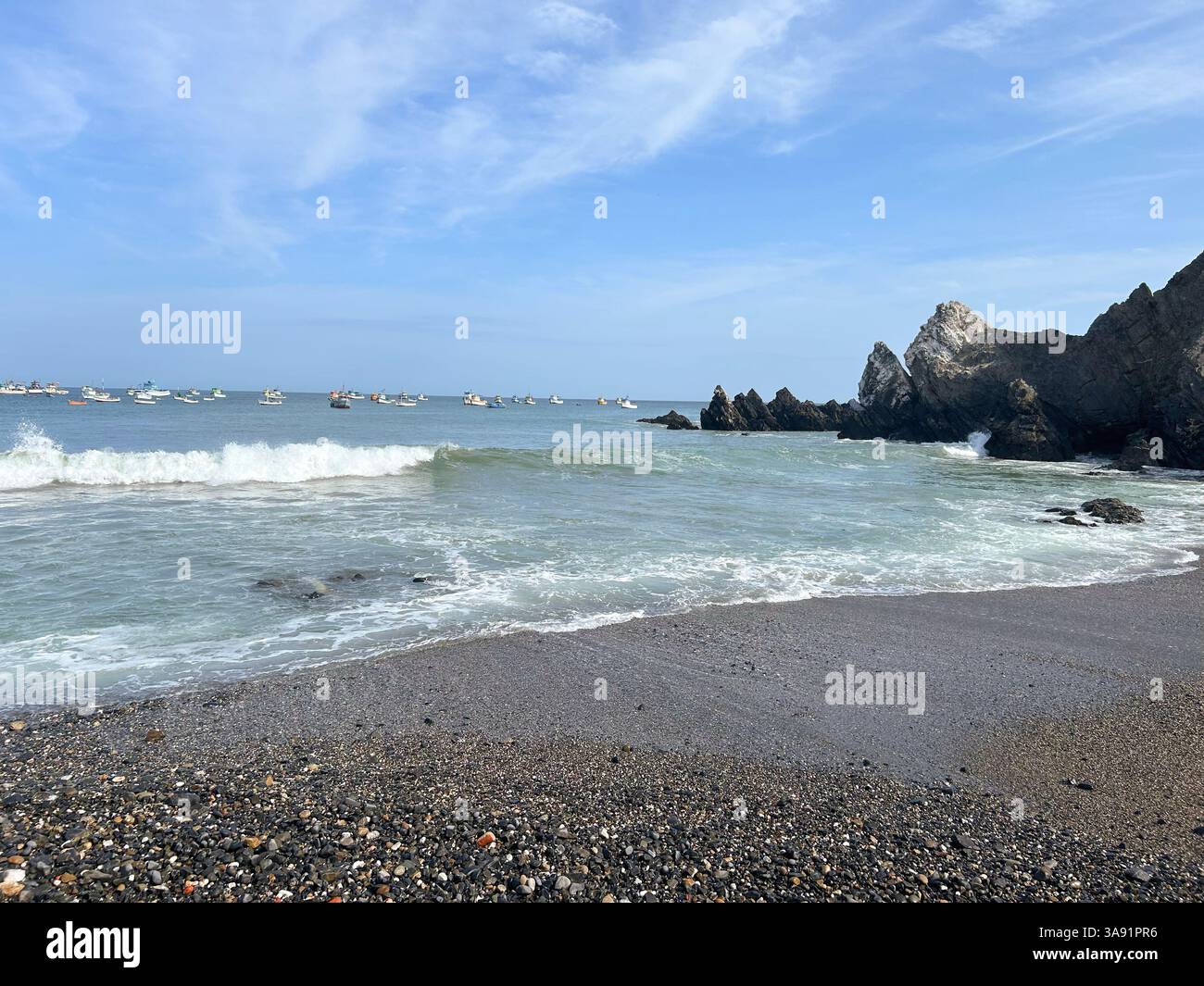 Coastal Landscape with Rocky Shoreline, Boats, and Blue Sky at Yacila ...