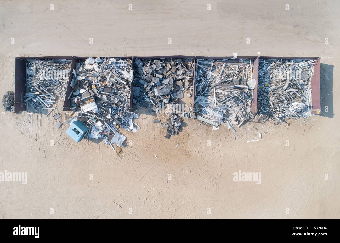 A pile of trash is stacked in a row. The trash is mostly made up of ...