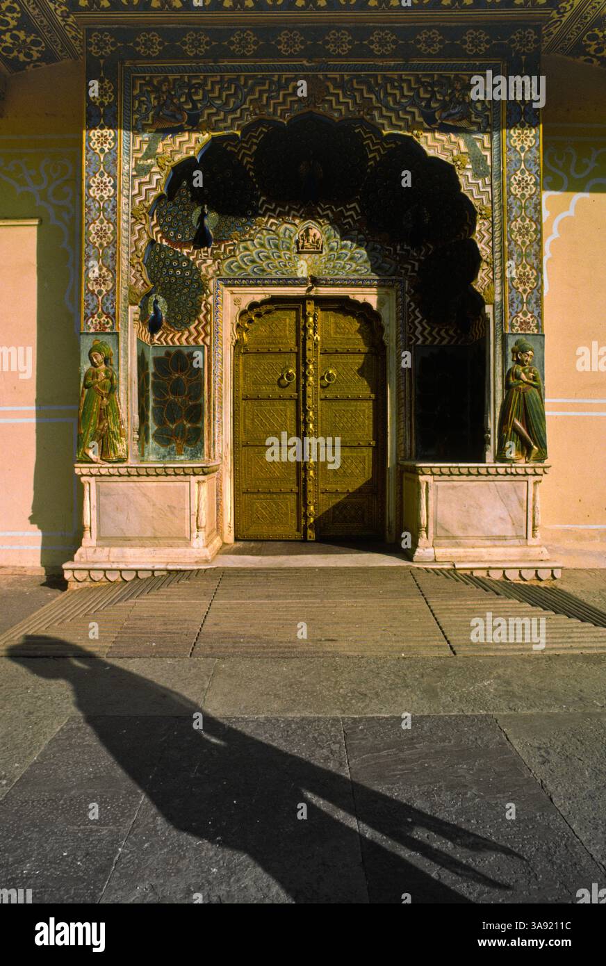 the Peacock Doors with a palace guard's shadow in Chokri Sarhad or City ...