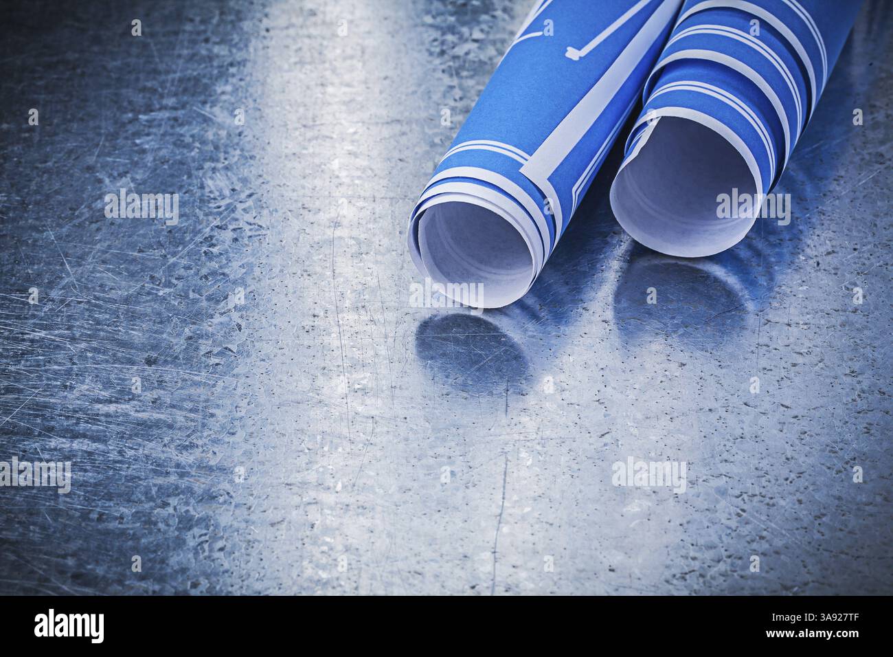 Stack of blue construction plans on metallic background building ...