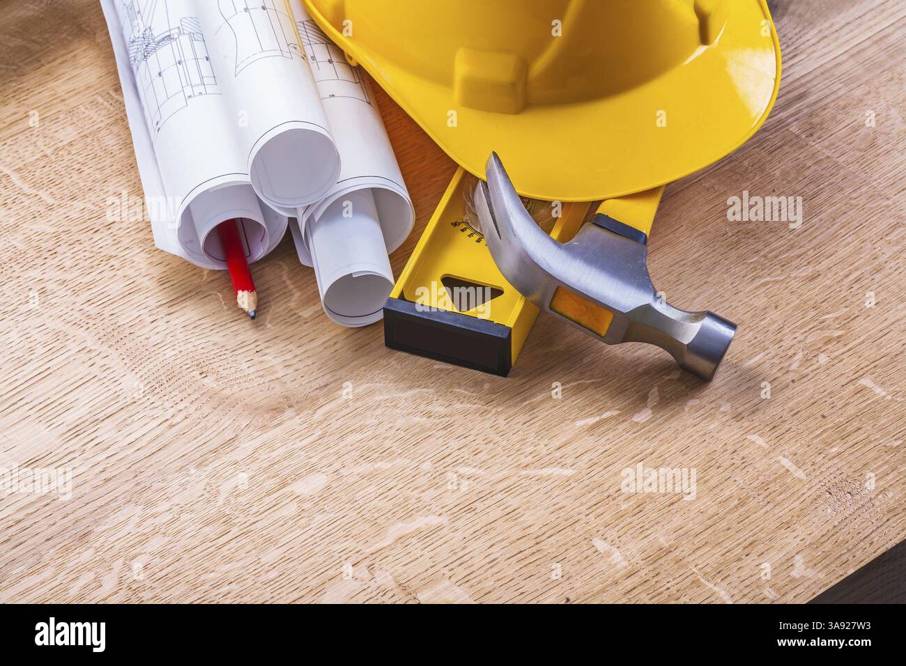 Hardhat level hammer blueprints pencil on wooden boards Stock Photo - Alamy