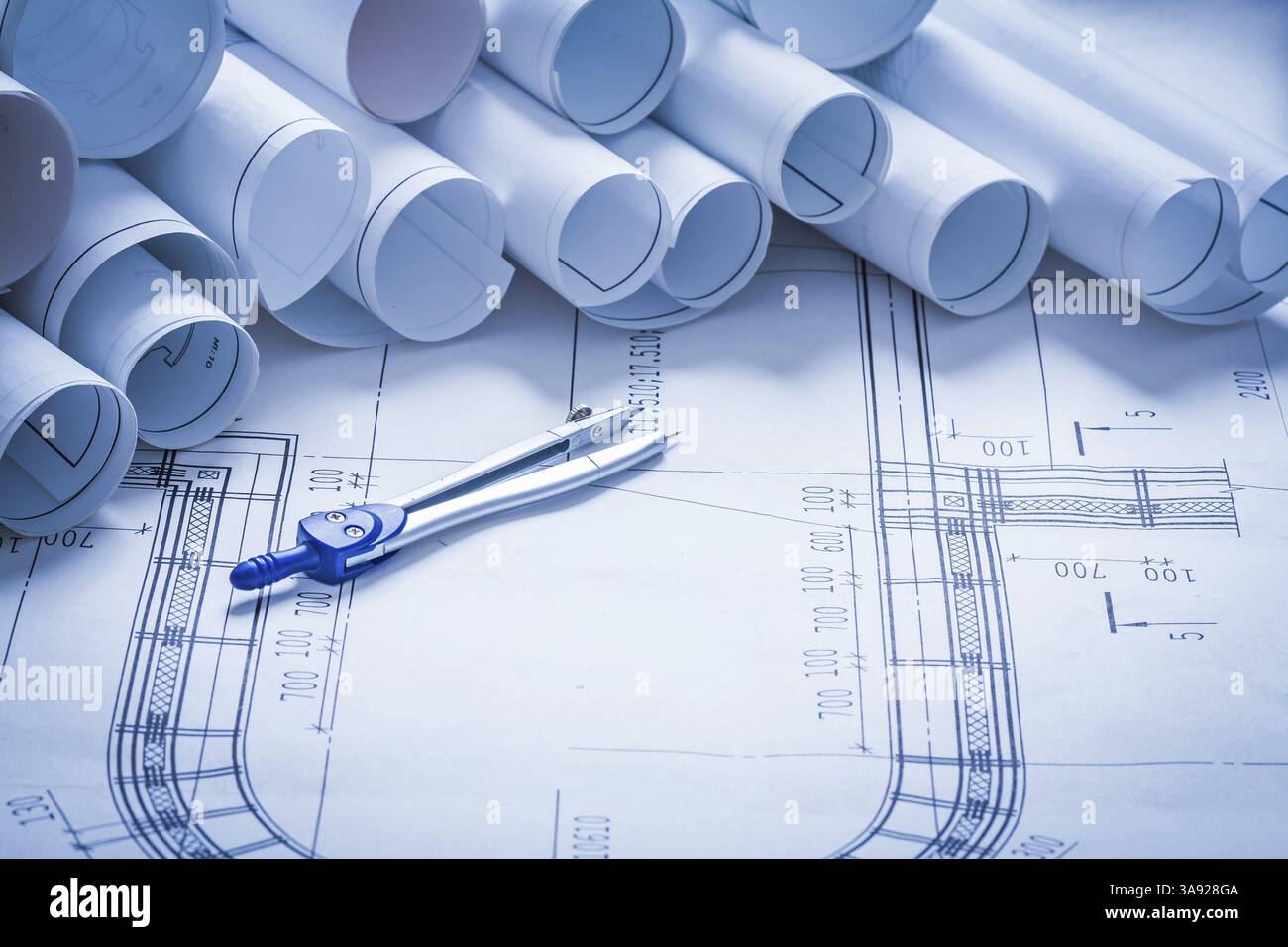 Pair of compasses with blueprint rolls building and architecture ...