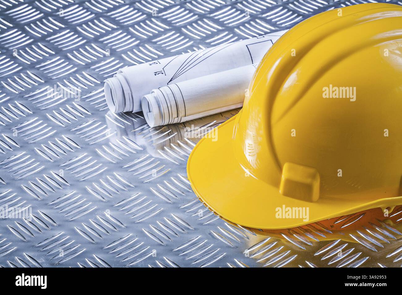 Blueprint rolls building helmet on grooved metal plate construction ...