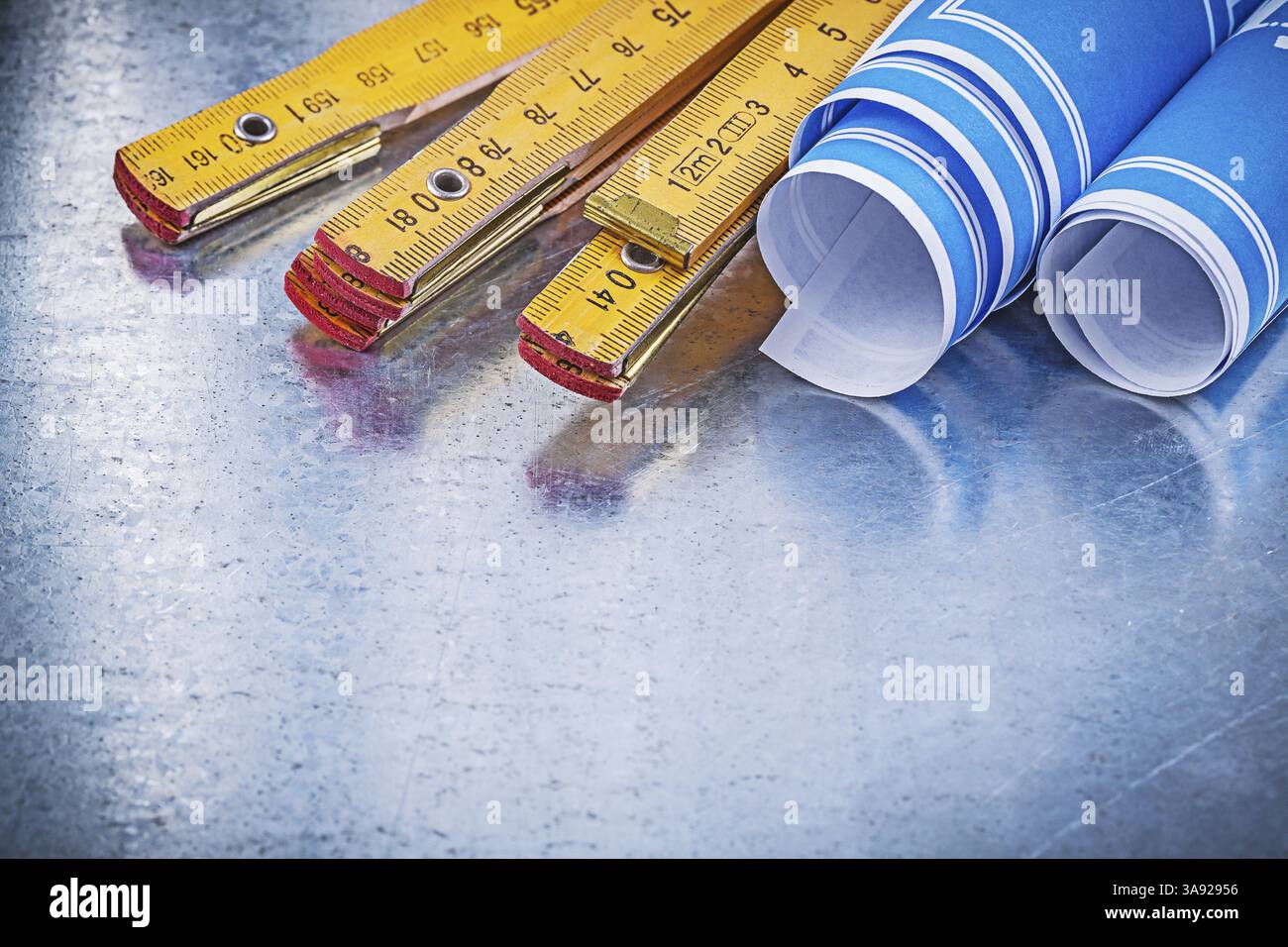Set of blue construction drawings wooden meter on metallic background ...
