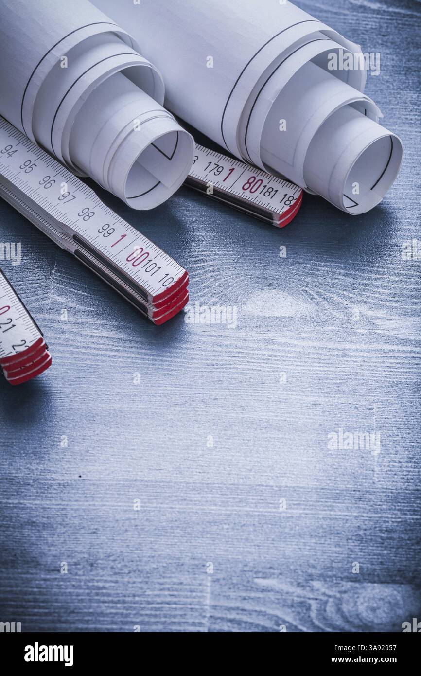 Vertical view rolled blueprints on wooden meter close up Stock Photo ...