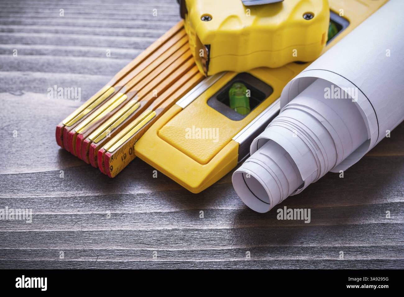 Tape-measure blueprints construction level and wooden meter on vintage ...
