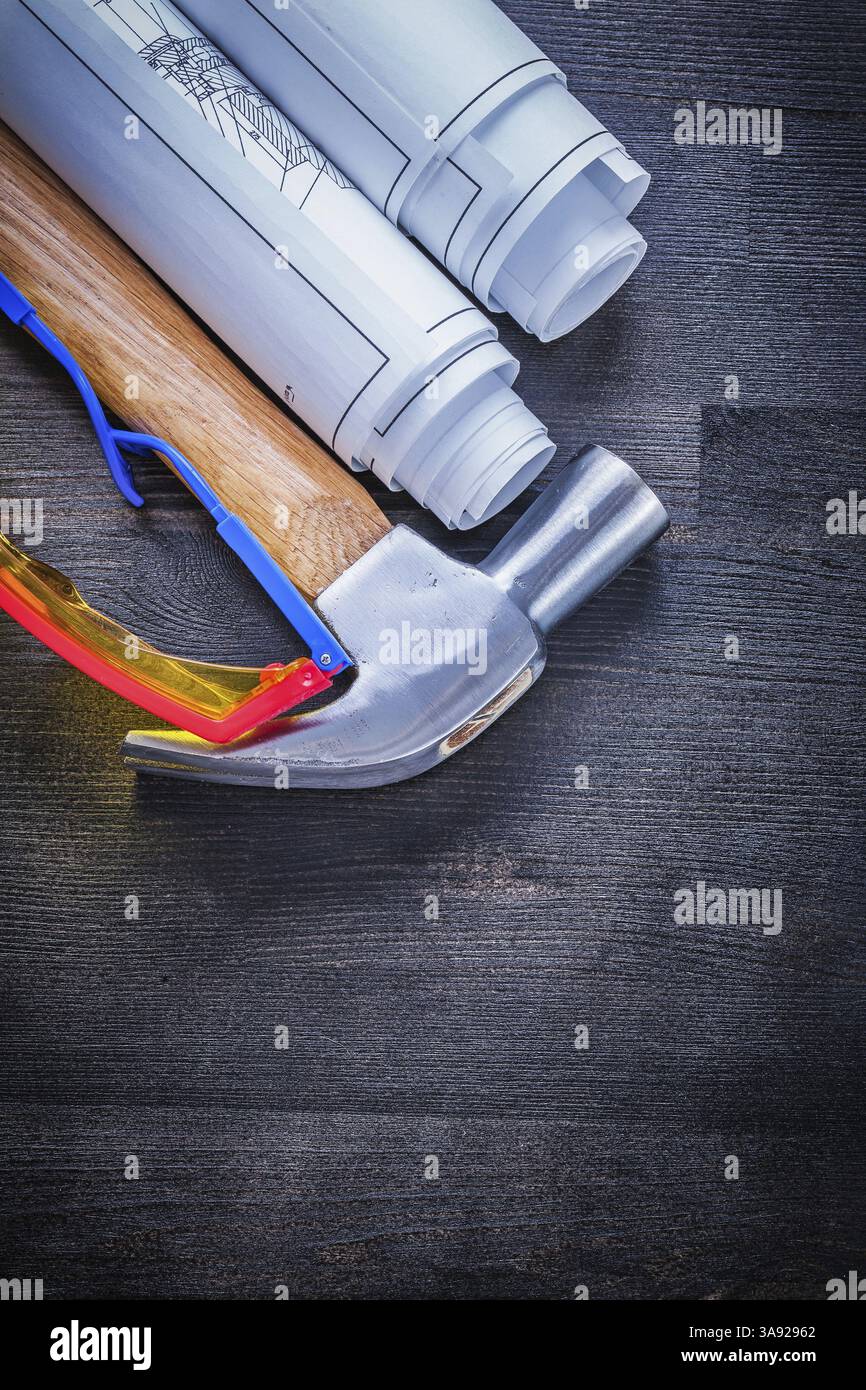 Vertical view goggles hammer rolled up blueprints Stock Photo - Alamy