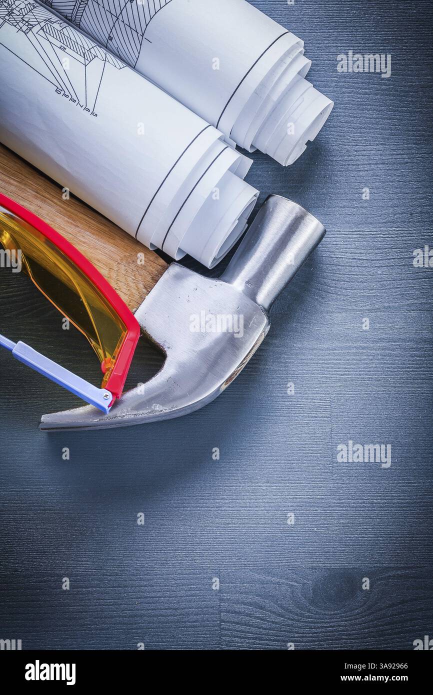 Vertical view rolled up blueprints hammer goggles Stock Photo - Alamy