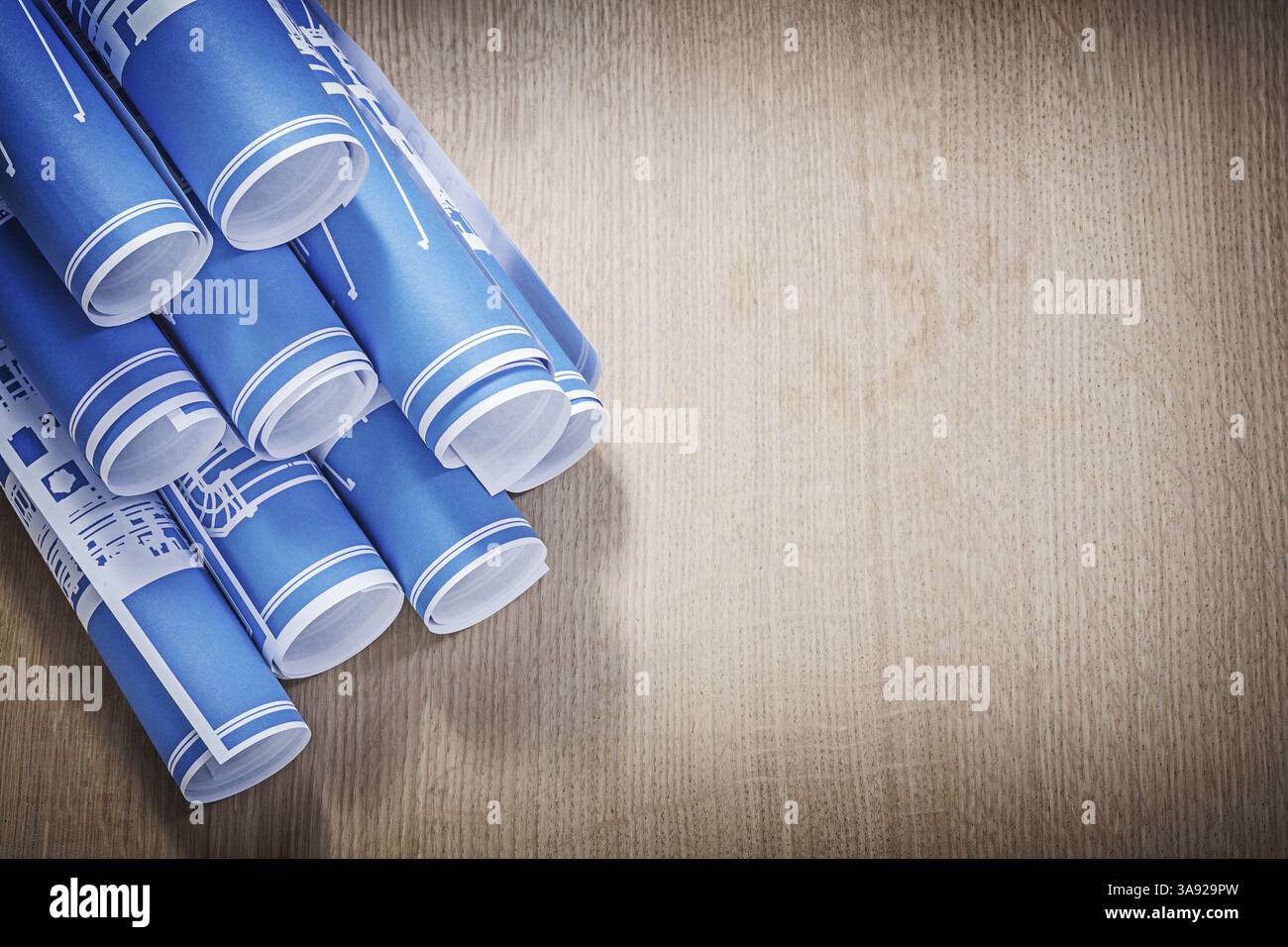 Heap of blue engineering drawings on wooden board construction concept ...
