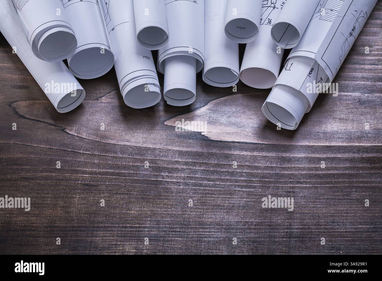 Stack of blueprint rolls on pine wooden vintage board maintenance ...