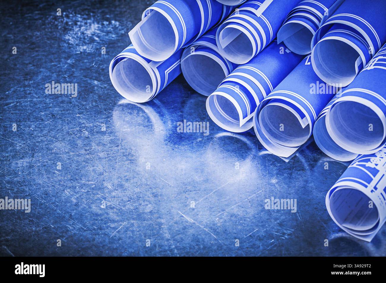 Stack of blue engineering drawings on metallic background construction ...