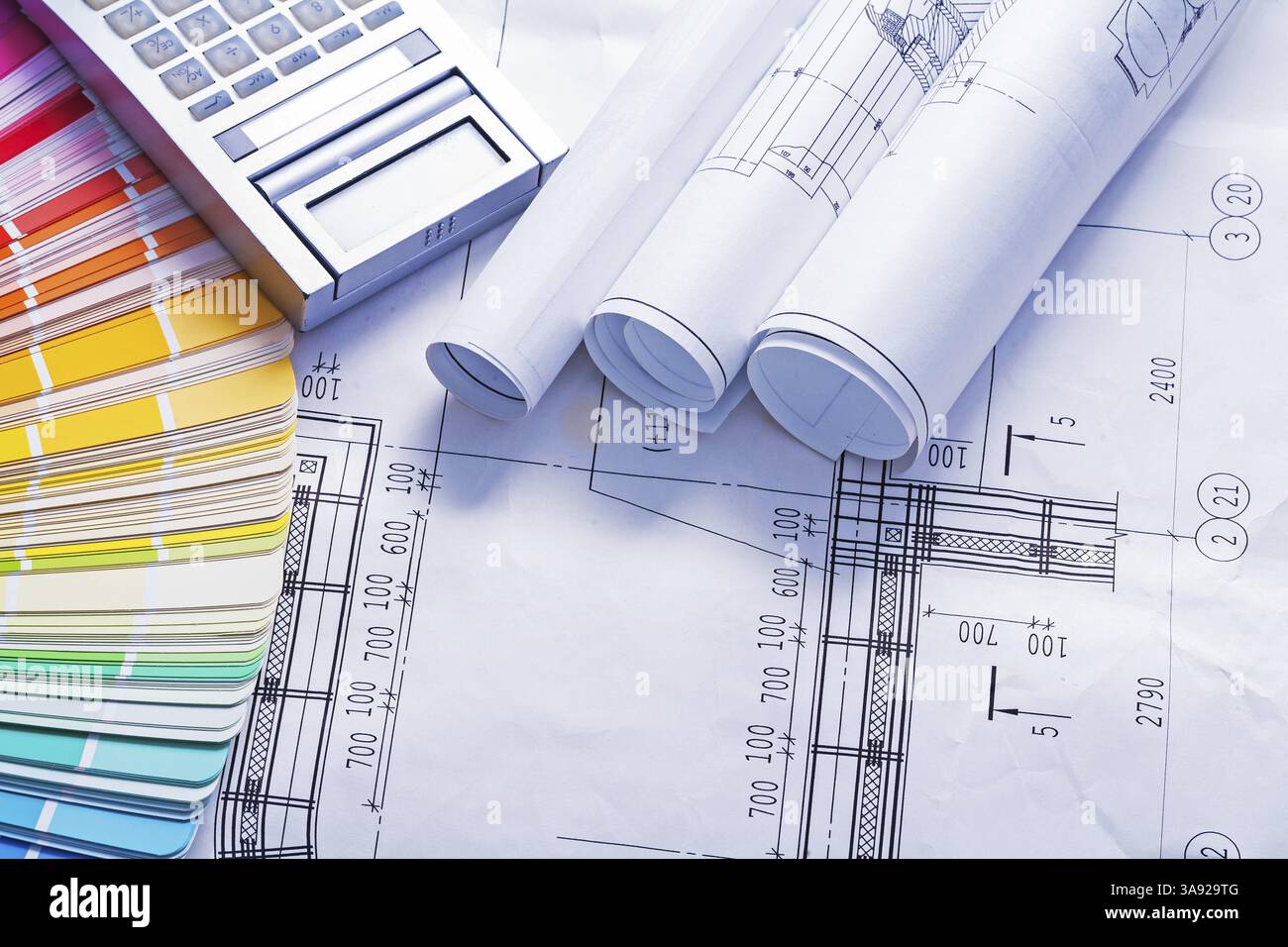 White rolled blueprints calculator and color palette construction ...