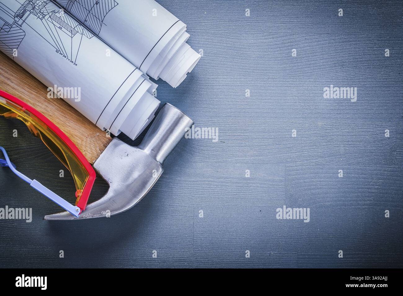 Horizontal view rolled up blueprints hammer goggles Stock Photo - Alamy