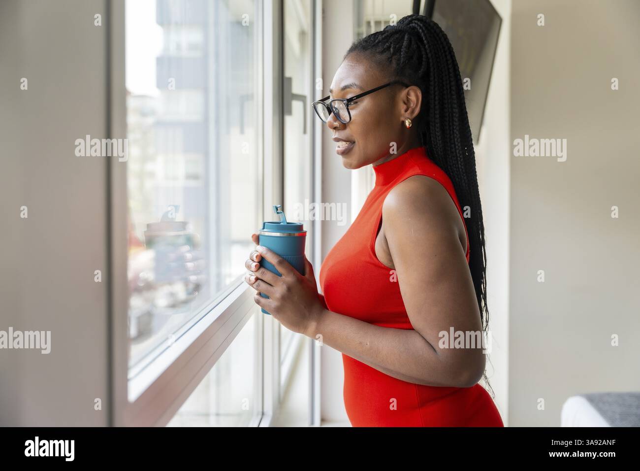 Black businesswoman enjoying a moment of peace while drinking from her ...