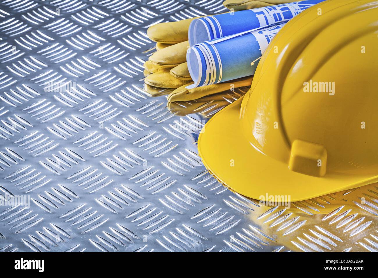 Blue engineering drawings building helmet safety gloves on corrugated ...