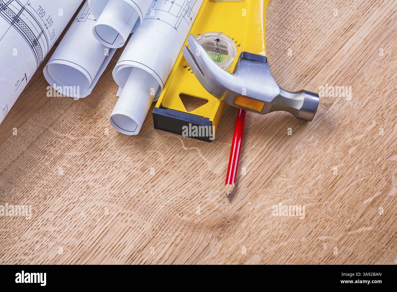 Level hammer pencil and rolls of blueprints construction concept Stock ...