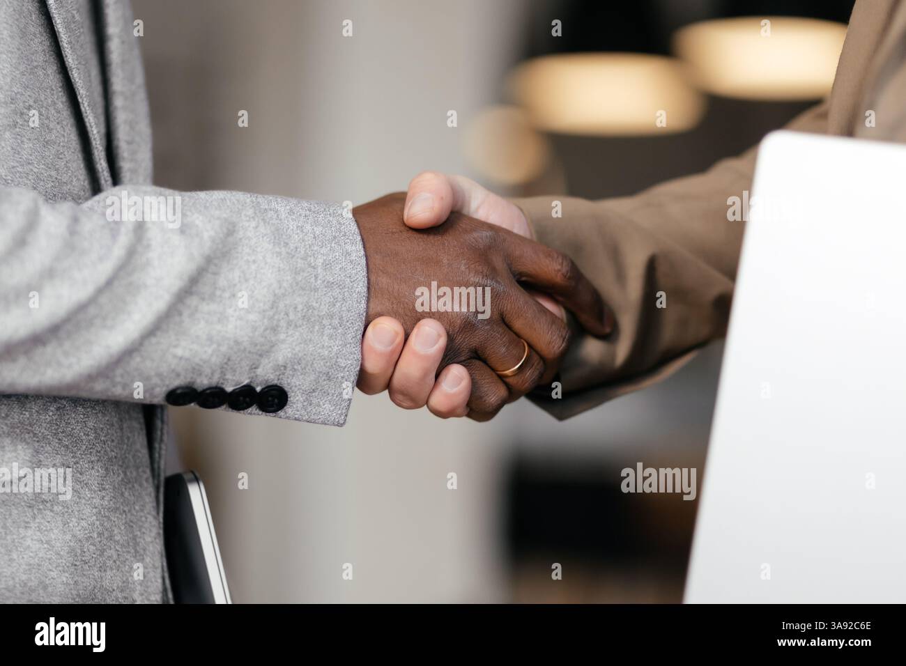 Close-up two businessmen of different nationalities shaking hands ...