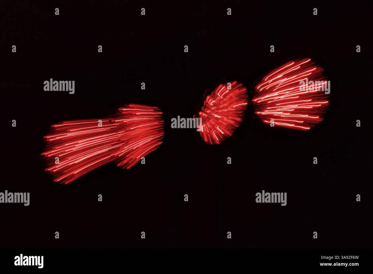 Red light reflections against a black background, traces of light from ...