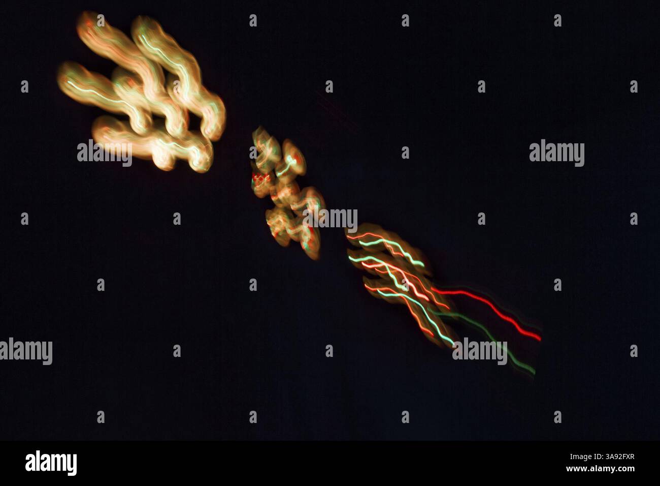 Light reflections against a black background, traces of light from ...