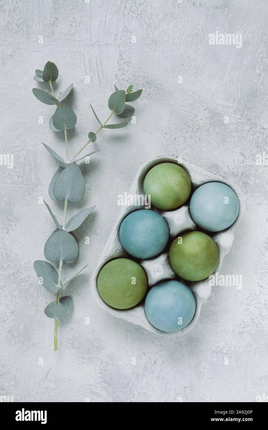 Easter colored eggs, in green and turquoise tones, with eucalyptus ...