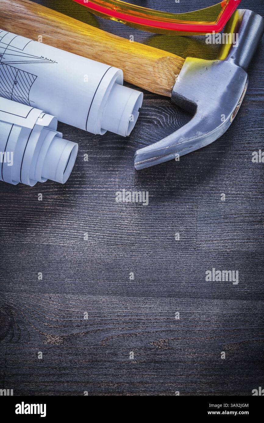 Vertical view rolls of blueprints hammer goggles Stock Photo - Alamy