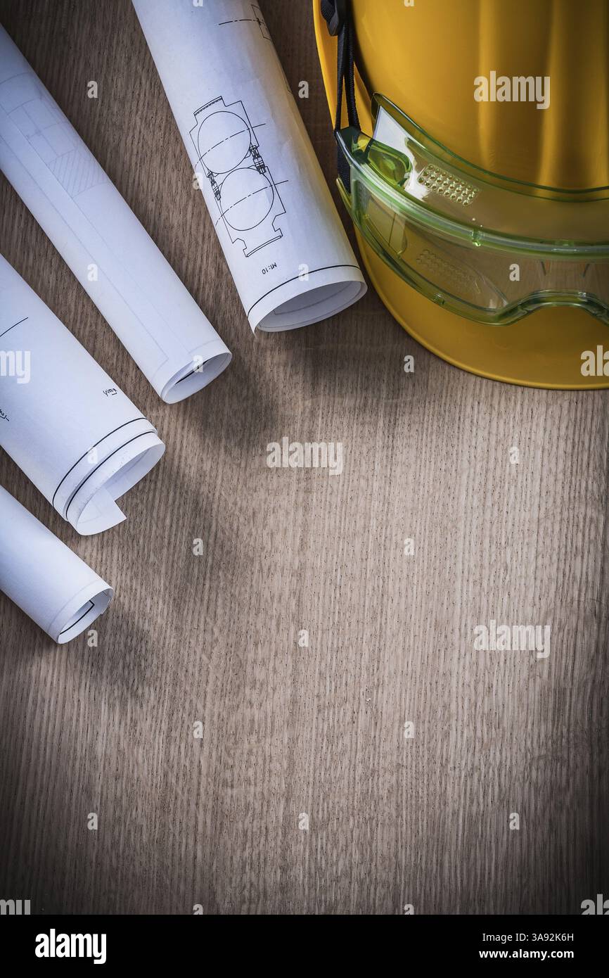 Set of safety goggles blueprint rolls and hard hat Stock Photo - Alamy