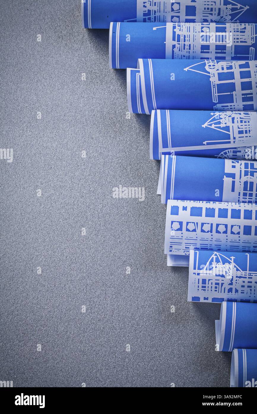 Heap of blue construction drawings on grey background vertical view ...