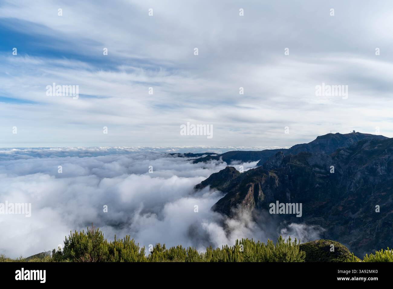 Rolling mountains covered in mist stretch across the horizon Stock ...