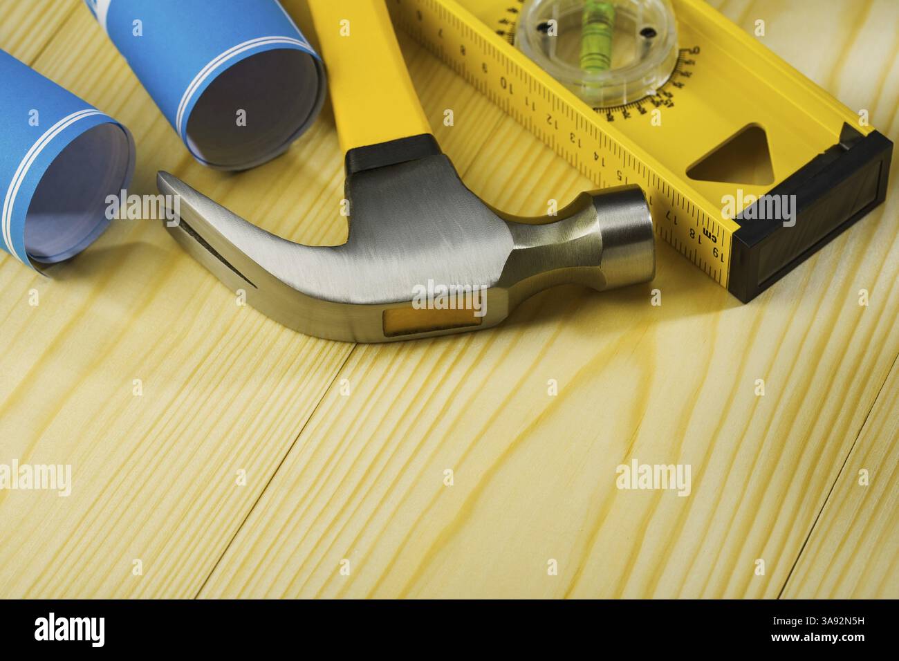 Hammer level and blueprints Stock Photo - Alamy