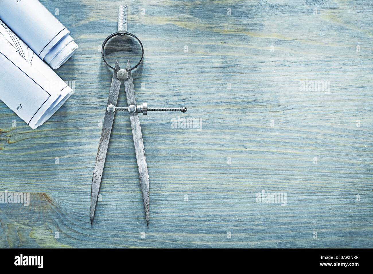Pair of compasses engineering drawings on wooden board construction ...
