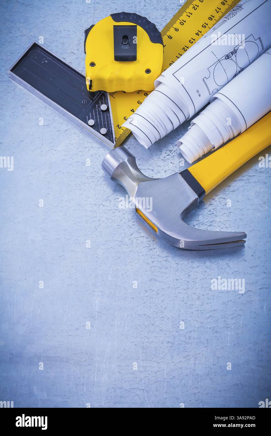 Metallic background with blueprints claw hammer square ruler and ...