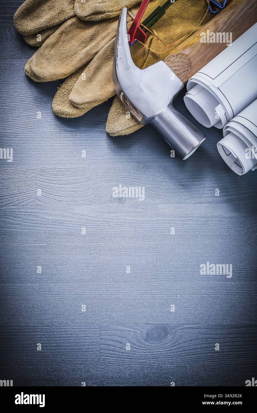 Vertical view safety gloves rolled blueprints hammer goggles Stock ...